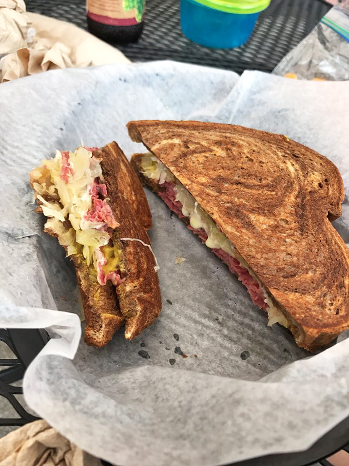 The Reuben, sliced in half to reveal its glorious layers—like architectural plans for the Taj Mahal of sandwiches.