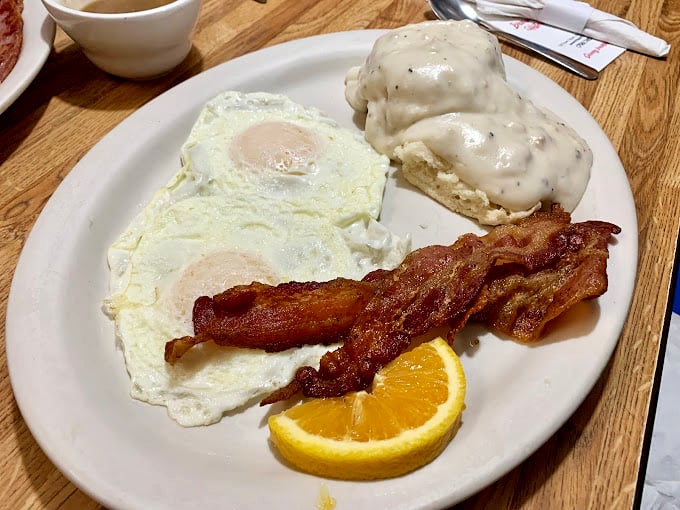 Eggs sunny-side up, bacon crisp enough to snap, and biscuits smothered in gravy – the holy trinity of Southern breakfast bliss.