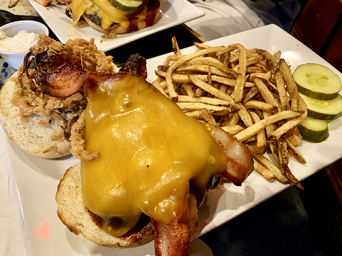 The bacon cheeseburger arrives with cheese cascading down the sides like a dairy waterfall. Whoever said "less is more" clearly never ate here.