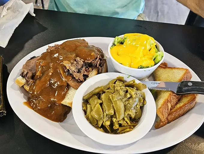 The holy trinity of comfort food: perfectly tender roast beef, seasoned green beans, and Texas toast—with gravy connecting it all like a delicious conductor.