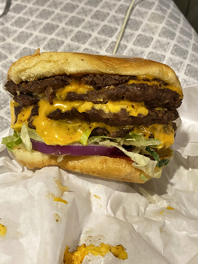 Layer upon layer of seasoned beef and melted cheese—this isn't just a burger, it's a geological event millions of years in the making.