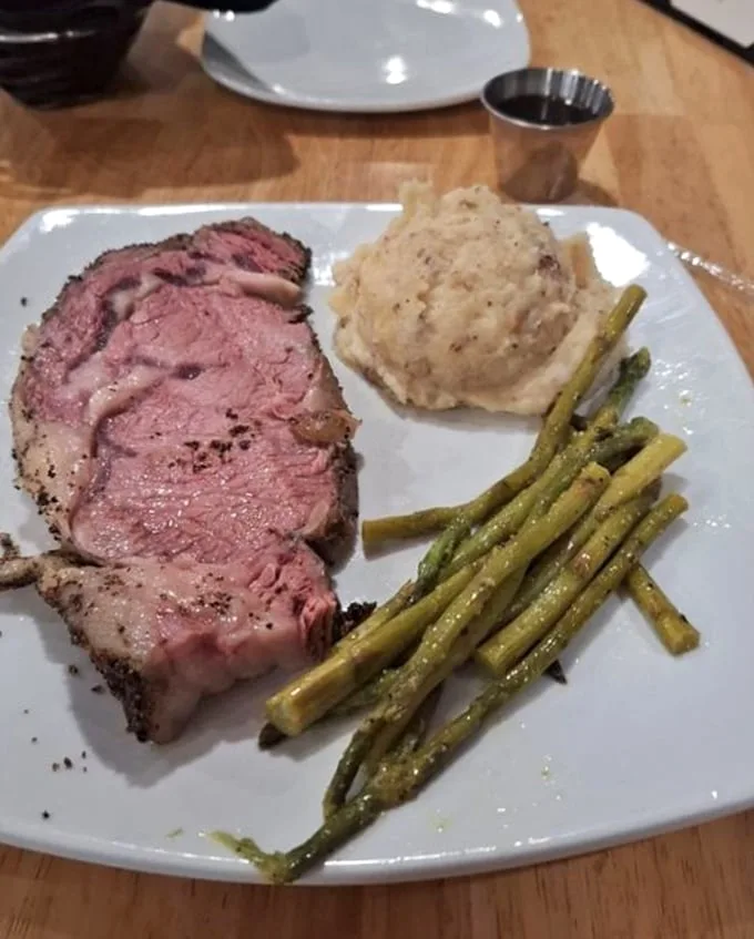 The kind of prime rib that makes vegetarians question their life choices – seasoned crust giving way to meat so tender it practically surrenders to your fork.