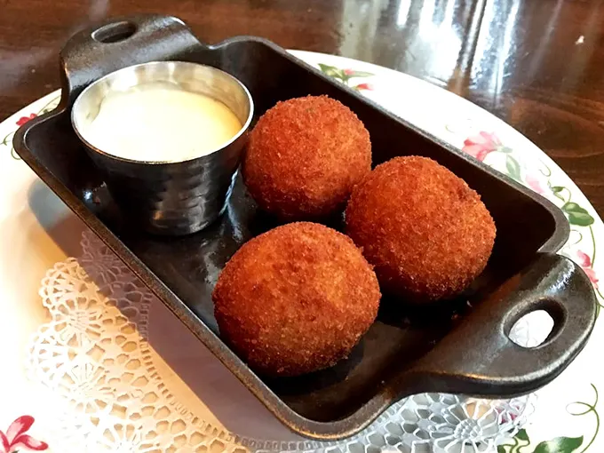 These golden-brown crab cakes aren't just appetizers—they're little crispy ambassadors of the sea, perfectly accompanied by a creamy dipping sauce that demands to be savored.