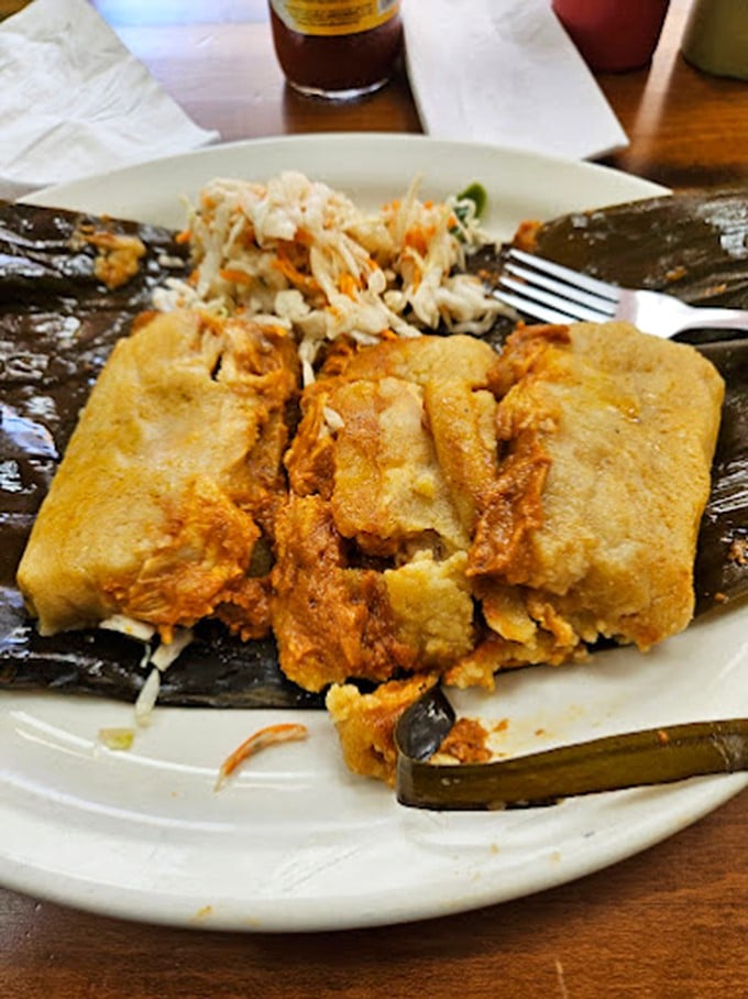 This tamale doesn't just fall apart – it surrenders with dignity, revealing inner secrets that will haunt your dreams in the best possible way. 