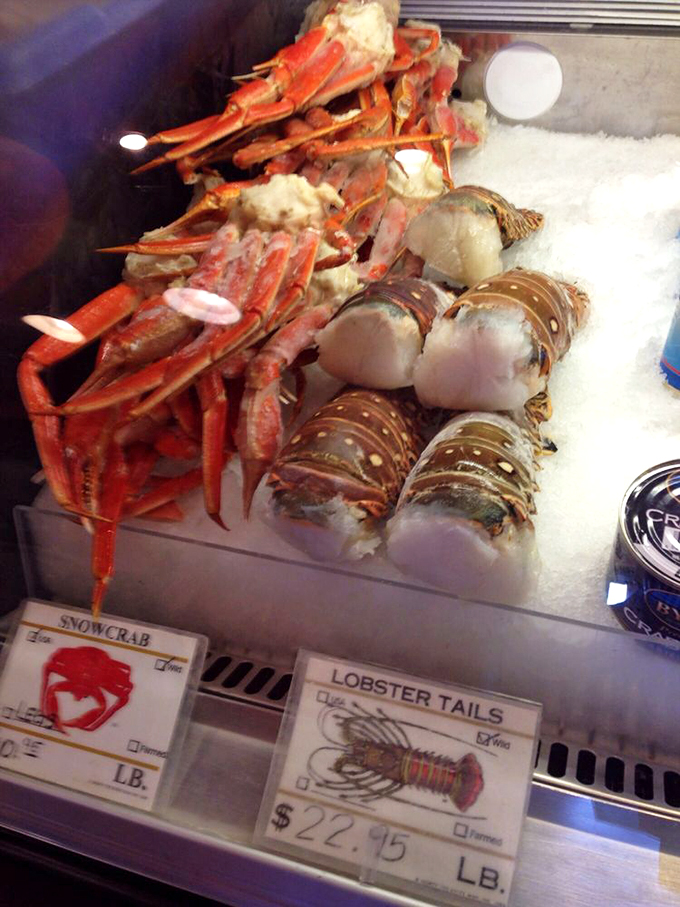 The seafood market display case—where lobsters and snow crabs await their destiny. It's like a beauty pageant where everyone's a winner.