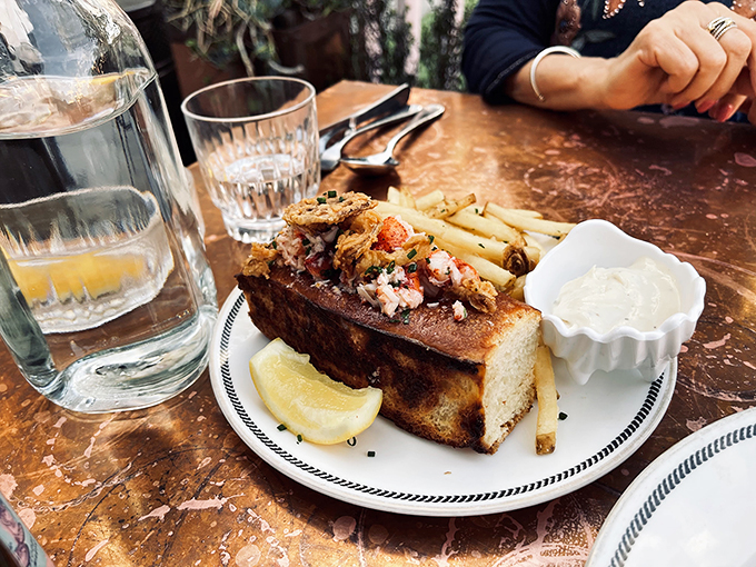 This isn't just a lobster roll – it's Maine's finest crustacean vacation-housing in a perfectly toasted brioche bun with crispy fries as neighbors.