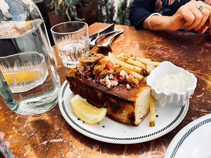 This isn't just a lobster roll – it's Maine's finest crustacean vacation-housing in a perfectly toasted brioche bun with crispy fries as neighbors.