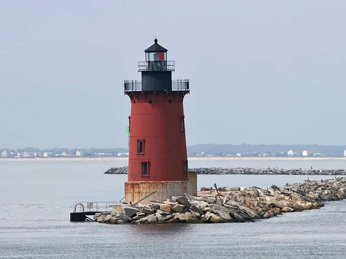 The iconic red lighthouse stands sentinel at the harbor entrance, a postcard-perfect reminder of Lewes' maritime heritage that's guided sailors home since 1924.
