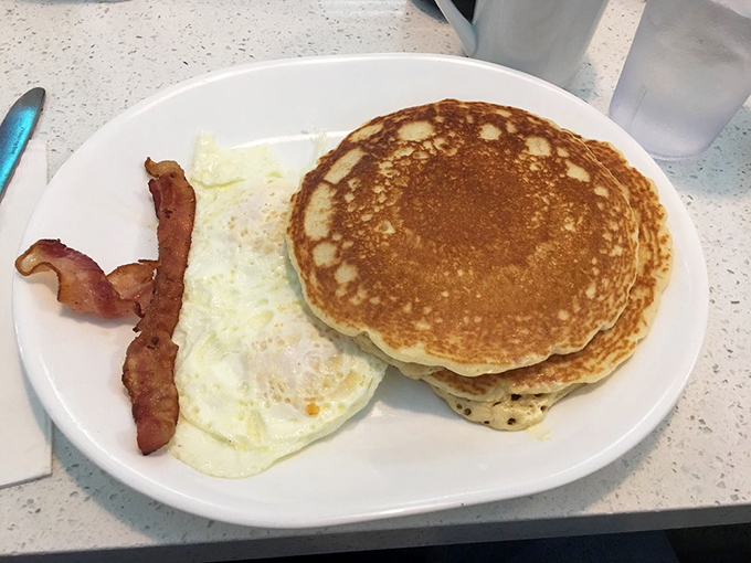 These pancakes aren't just breakfast, they're edible frisbees of joy – golden-brown on the outside, fluffy within, and large enough to require GPS.