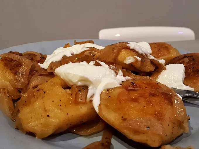 Pierogies that could start a religion—golden-brown pockets of potato perfection topped with caramelized onions and a dollop of sour cream that whispers, "Diet tomorrow."