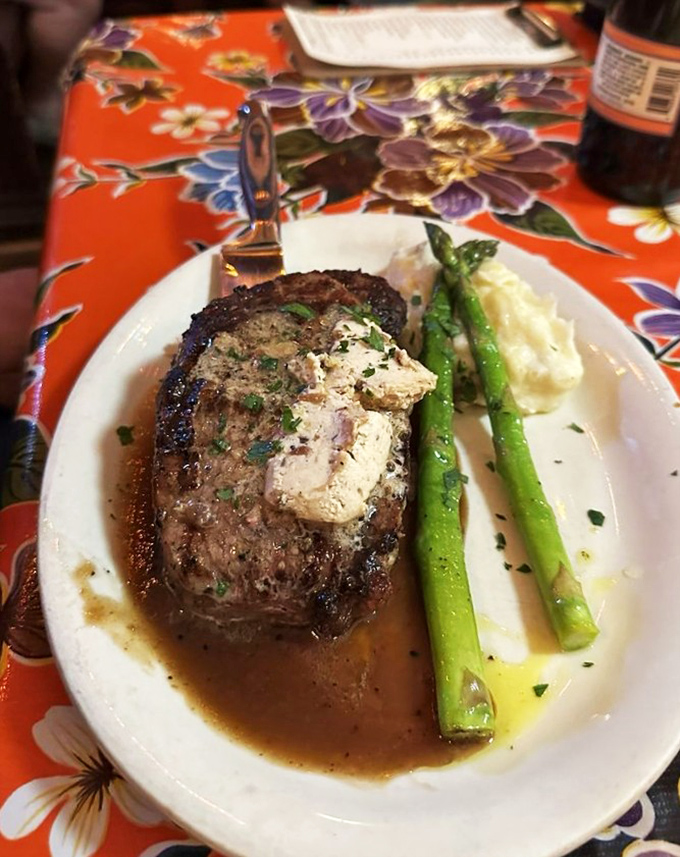 A perfectly seared steak with compound butter slowly melting into meat so tender it practically surrenders to your fork. Asparagus never had better company.