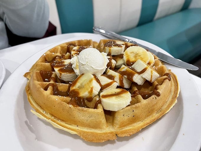 This isn't just a waffle—it's architecture with syrup. Bananas and ice cream transform breakfast into dessert, and nobody's complaining about it.