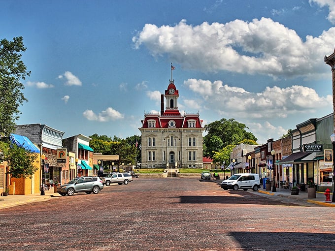 Cottonwood Falls' courthouse stands like a Victorian masterpiece against the Kansas sky. That red roof practically winks at you!
