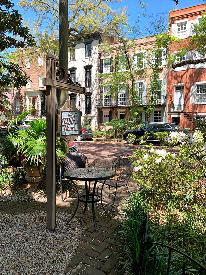 Mrs. Wilkes' courtyard entrance feels like the gateway to a Southern food fantasy – Narnia, but with better biscuits and no talking lions.