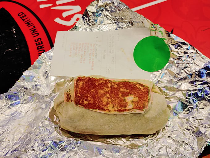 Even wrapped to go, this burrito maintains its dignity and structural integrity—the Fort Knox of portable meals, guarding its treasures until you're ready.