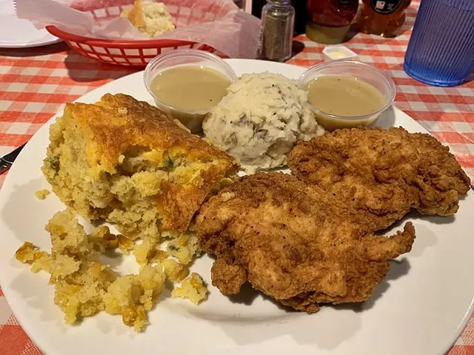 This isn't just fried chicken—it's an edible time machine to when recipes were passed down, not mass-produced. The cornbread alongside isn't playing second fiddle to anyone.