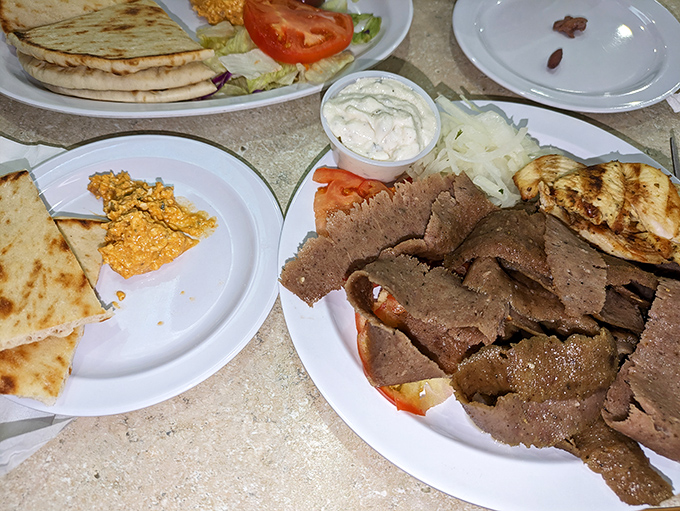 Gyro meat sliced thin enough to read the newspaper through, piled high with all the fixings—proof that sometimes more is exactly right.