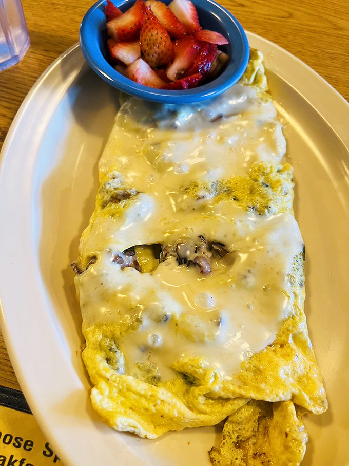 Eggs, cheese, and fresh strawberries – breakfast's perfect trinity. Whoever said you can't have your fruit and eat your omelet too?