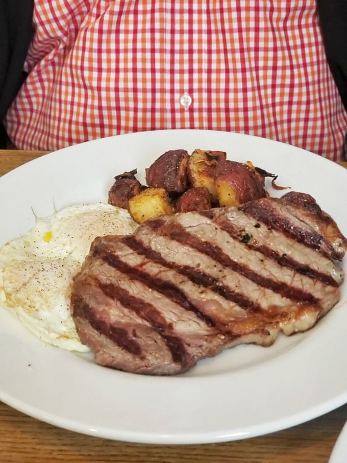 Breakfast of champions: a juicy steak with eggs and home fries. Not all heroes wear capes—some wear aprons and know exactly how to cook meat.