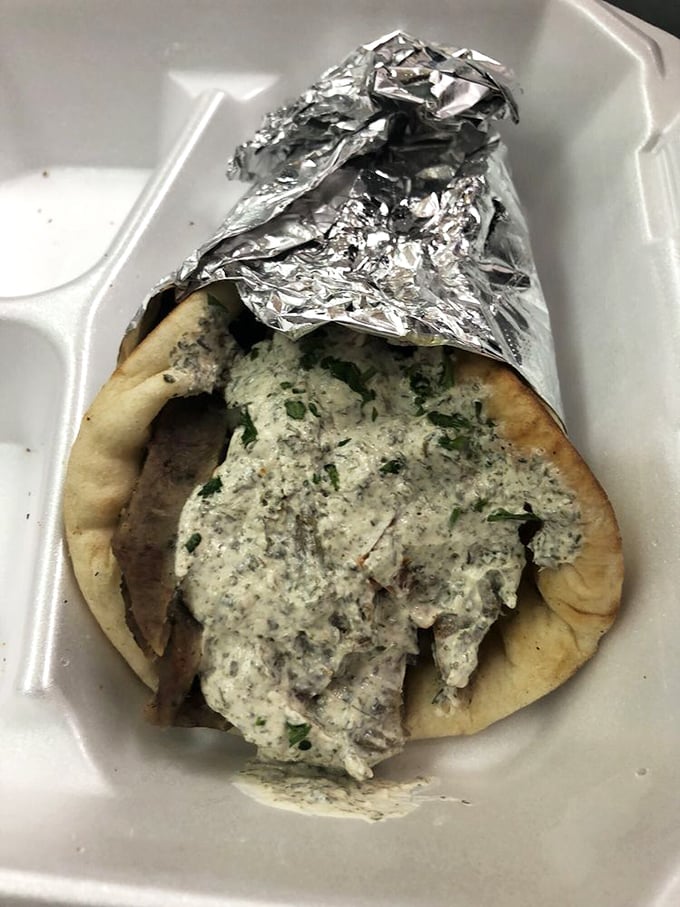 Behold the gyro in its natural habitat – juicy, savory meat nestled in a pillowy bun with melted cheese. This is what sandwich dreams are made of.