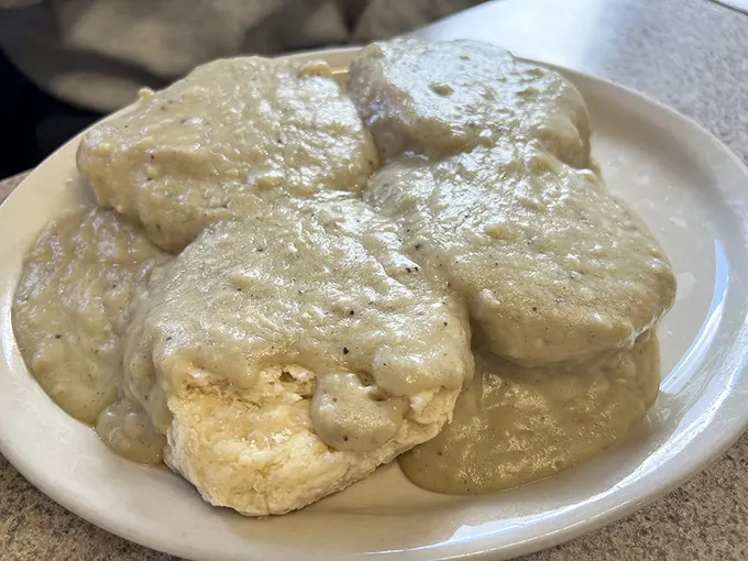 Biscuits and gravy that look like they were conceived during a particularly ambitious dream – comfort food that laughs in the face of moderation.