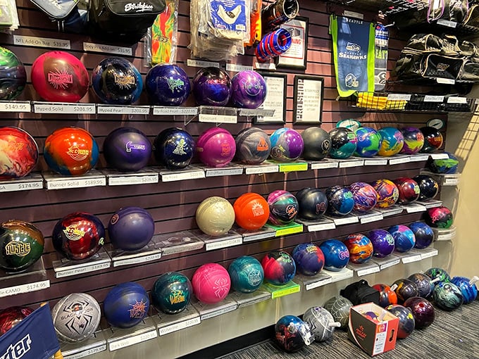 Bowling balls lined up like exotic fruits at a market—each one promising different curves, speeds, and excuses for gutter balls.