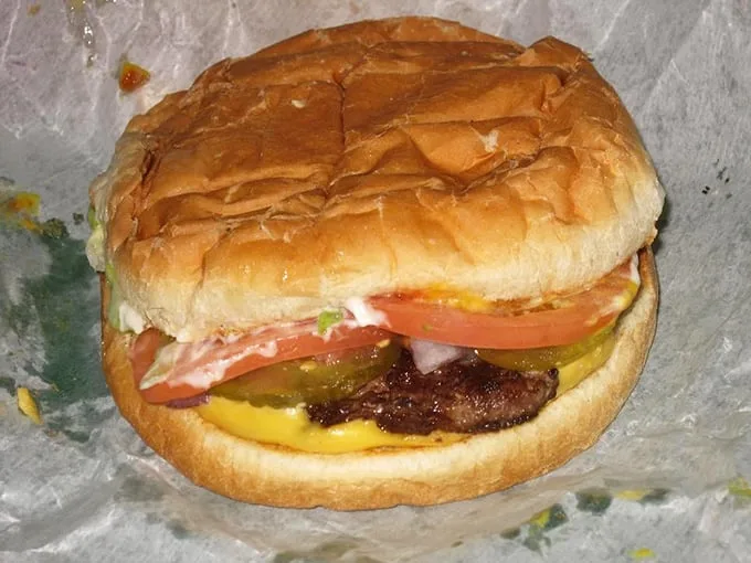 The classic Whatta-Burger in its natural habitat—simple, honest, and dressed with fresh veggies. Poetry between buns.