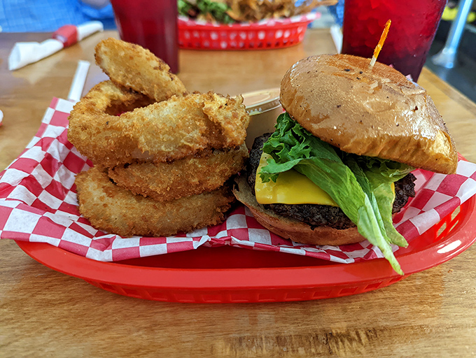 This isn't just a burger—it's edible architecture. The crispy onion rings serve as delicious golden halos for this sandwich masterpiece.