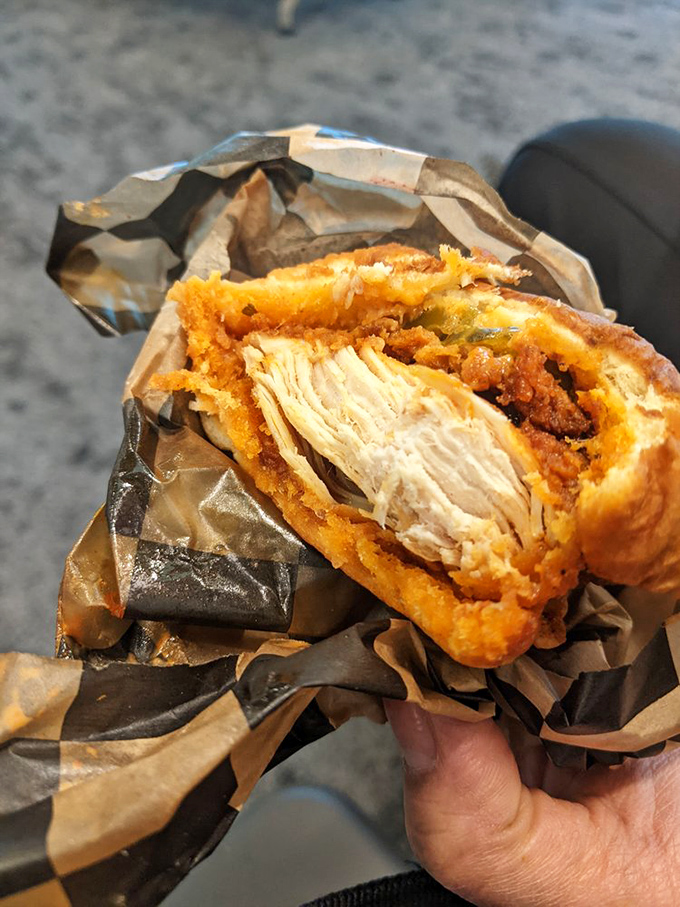 Cross-section of perfection: juicy chicken, crispy coating, and that signature spice blend that's been bringing tears of joy since the 1930s.