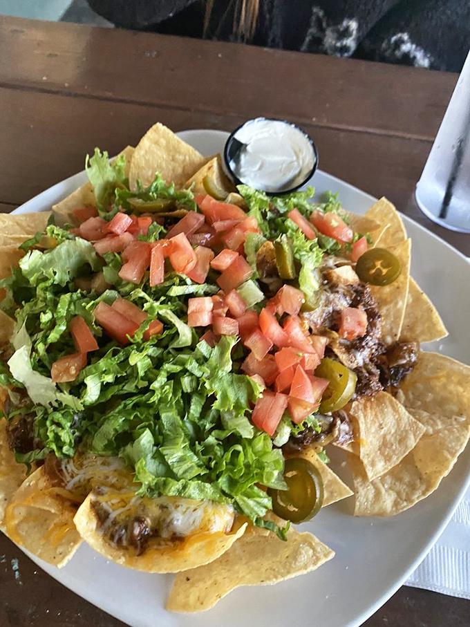 These nachos aren't trying to be fancy—they're just trying to be delicious. Mission accomplished with a mountain of cheese, fresh veggies, and jalapeños for kick.
