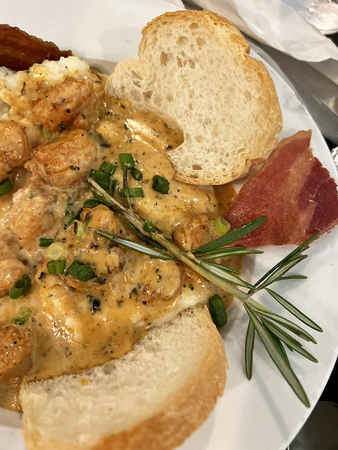 Breakfast architecture at its finest – layers of flavor built on a foundation of creamy grits, with shrimp so fresh they practically wink at you.