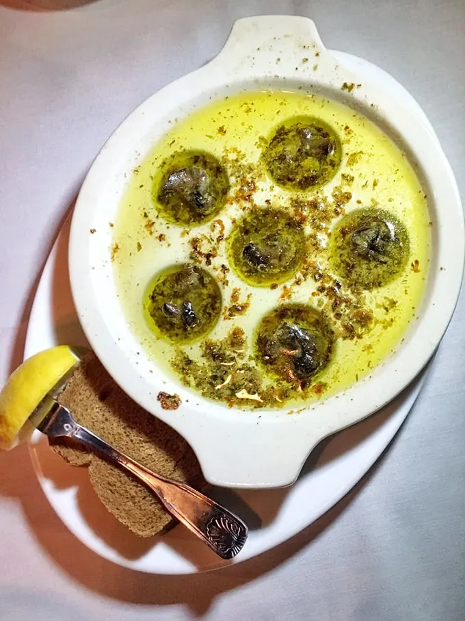 Escargot: where butter, garlic, and herbs transform something you'd avoid in your garden into something you'd fight your dining companion for.