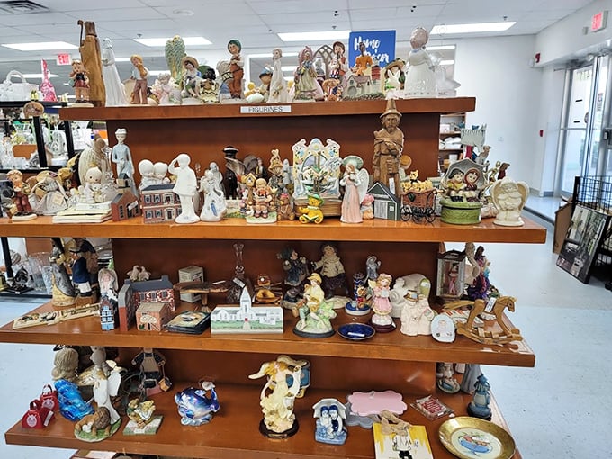 The figurine section—where porcelain angels, ceramic children, and decorative knickknacks form a miniature society frozen in perpetual politeness. 