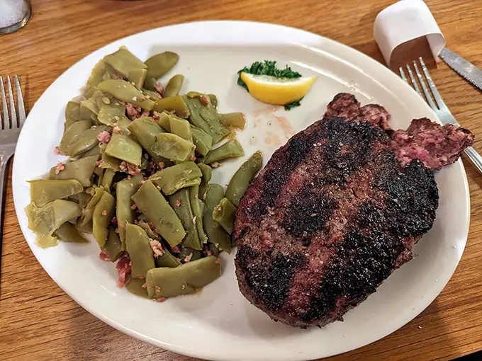 Green beans with bacon bits alongside a steak with that textbook char? This isn't just dinner; it's proof that sometimes the classics become classics for a very good reason.