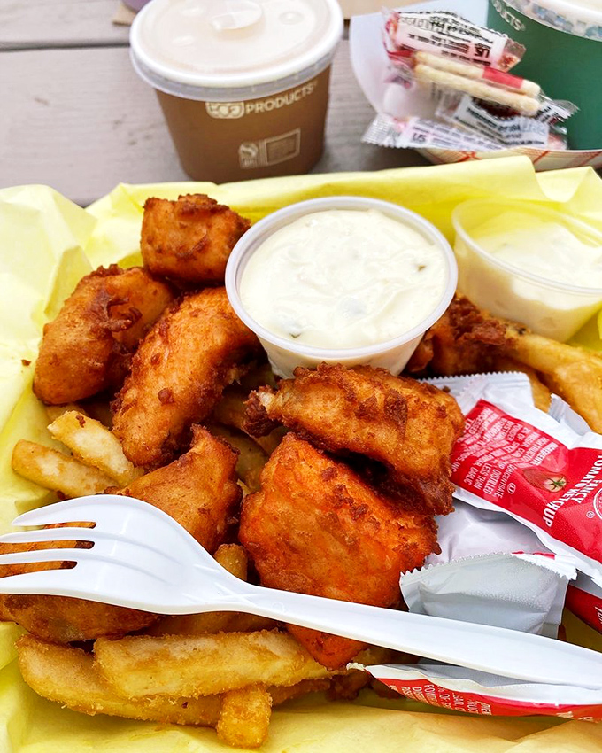 Fried seafood paradise on yellow paper—where calories don't count and happiness comes battered. The tartar sauce is just a bonus.