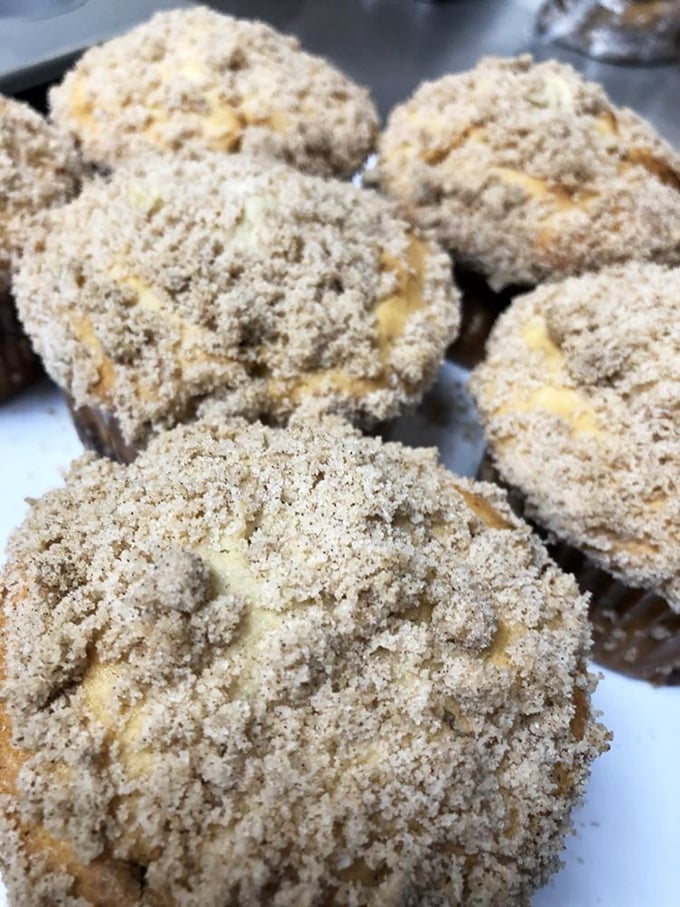These cinnamon streusel muffins look like they're wearing tiny sweaters knitted from sugar and spice – cozy comfort in every crumbly bite.