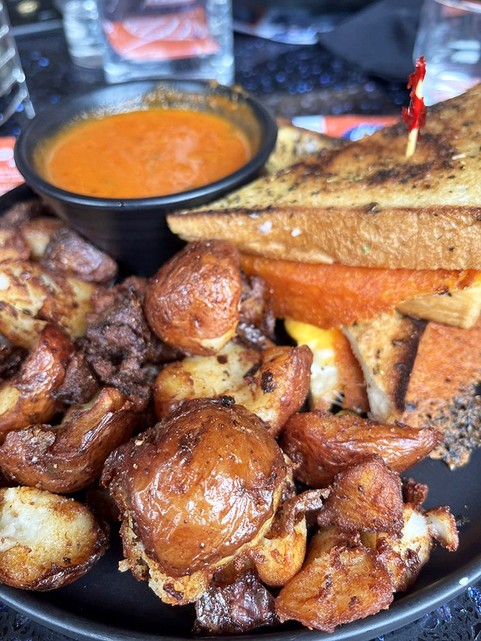 Crispy potatoes that could make a French chef weep, alongside a sandwich with the kind of cheese pull that deserves its own slow-motion sequence.
