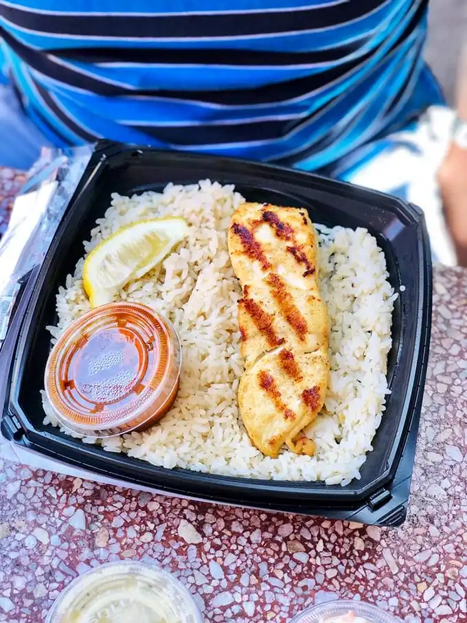 Proof that not everything delicious needs to be fried – this perfectly grilled fish on a bed of rice offers a lighter option without sacrificing flavor.
