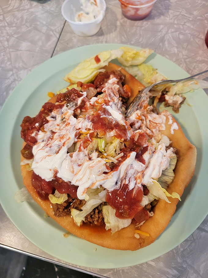 The Indian taco arrives like an edible work of art—a festival of textures and flavors that puts ordinary tacos to shame.