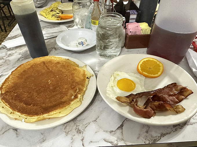 The pancake that launched a thousand carb cravings—golden, plate-sized, and worthy of its own Instagram account (if only the regulars cared about such things).