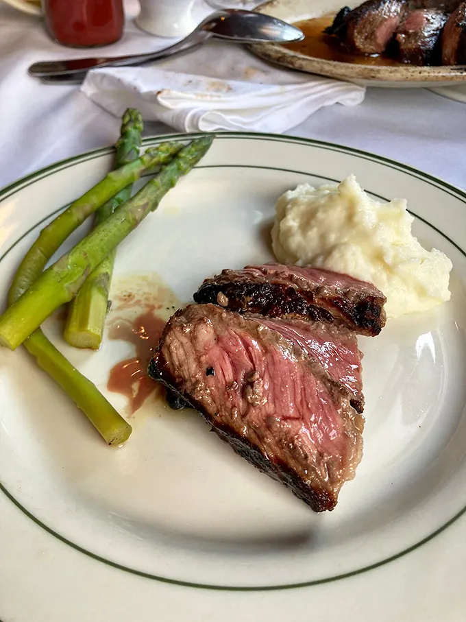 Behold the money shot—a perfectly cooked steak with asparagus and mashed potatoes. Like a Norman Rockwell painting you can eat.