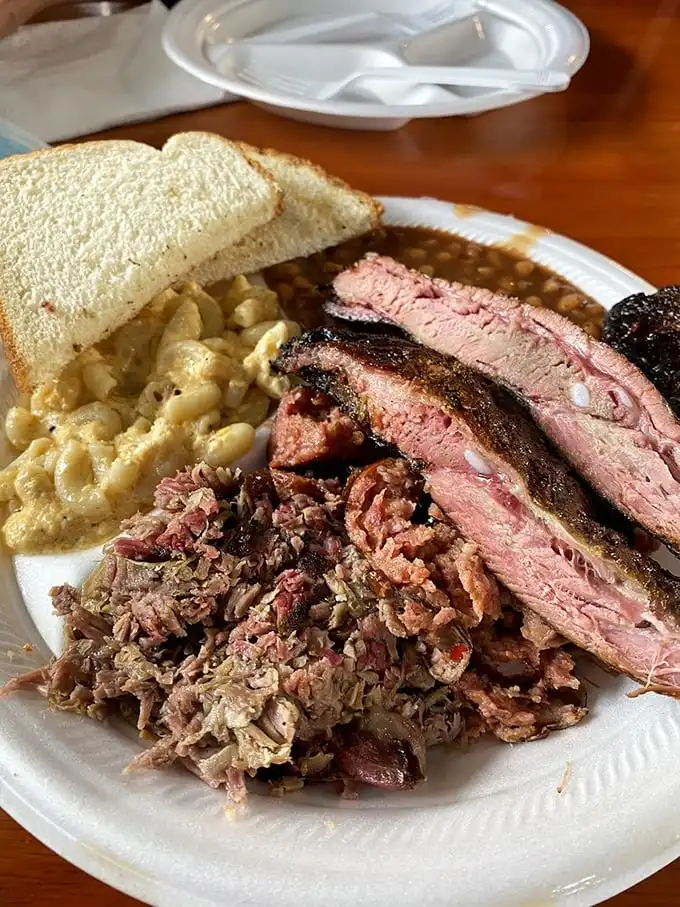The holy trinity of barbecue—pulled pork, ribs, and mac and cheese—a plate that would make even vegetarians question their life choices.