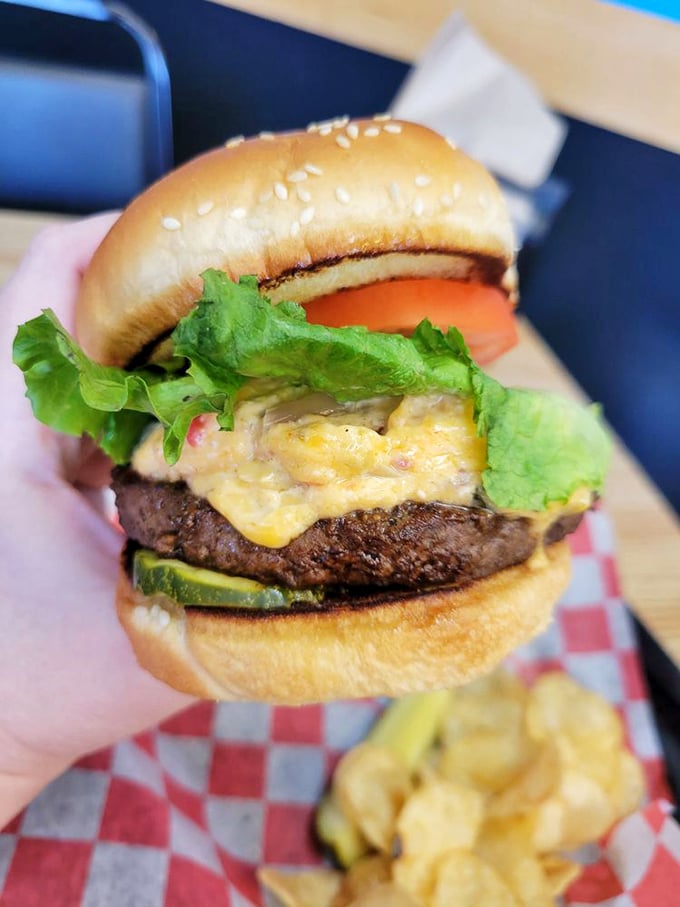 This isn't just a burger—it's a towering achievement of beef, cheese, and fresh veggies that requires jaw exercises before attempting to take the first bite.