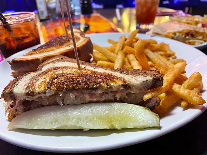 This isn't just a burger—it's a skyscraper of flavor with pastrami reaching for the heavens and fries standing guard like delicious sentinels.