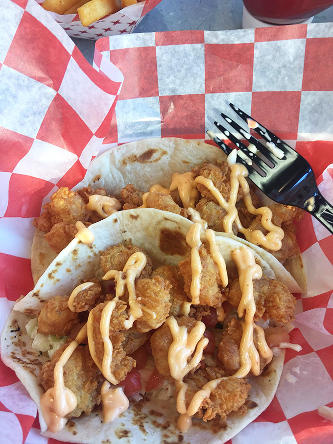 Soft tortillas cradle crispy treasures like a grandmother holding a newborn – with love, care, and a splash of sauce.