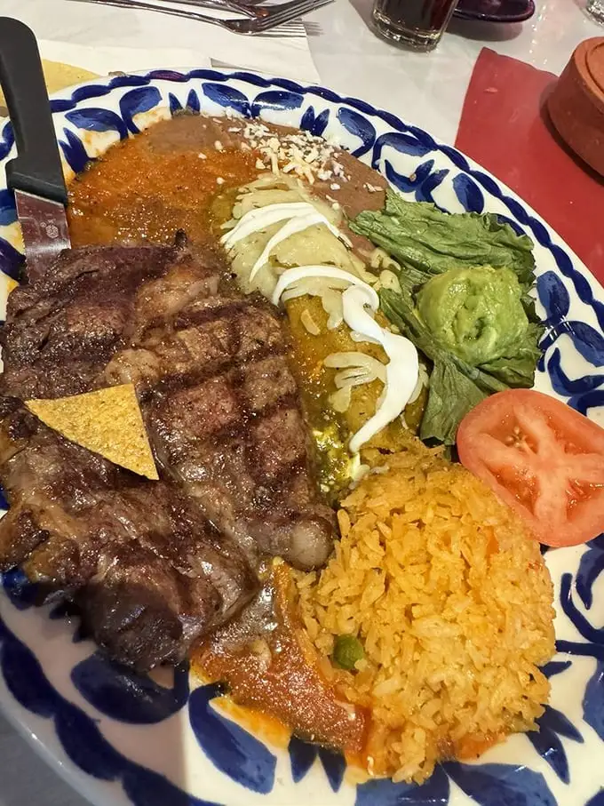 The steak and enchilada combo plate—for when you can't decide between land and land. That perfectly charred beef is singing a siren song.