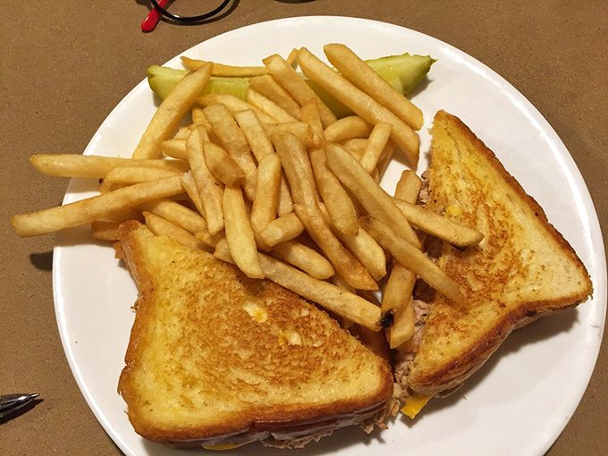 Golden-grilled perfection meets French fry abundance—this tuna melt doesn't just satisfy hunger, it creates a moment of pure sandwich bliss.