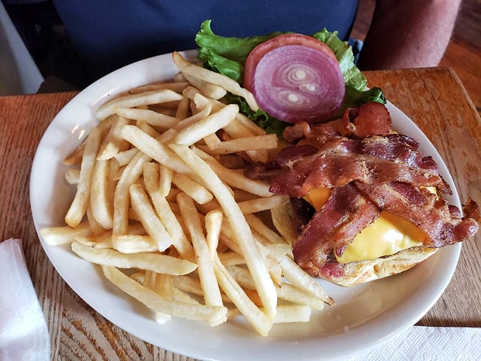 Bacon arranged like a crown atop melted cheese—because in the burger kingdom, this is royalty that doesn't require formal attire.