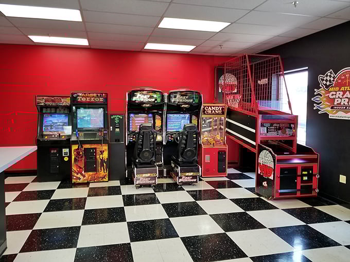 The arcade area – where racing adrenaline transitions to button-mashing nostalgia. Warning: may trigger flashbacks to Reagan-era quarters disappearing into Pac-Man.
