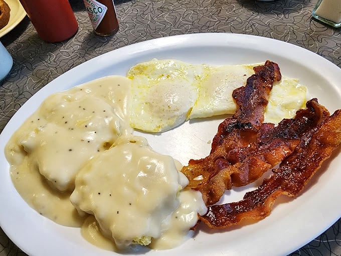 Biscuits smothered in country gravy alongside perfectly cooked eggs and bacon – the breakfast trinity that's been solving life's problems since time immemorial.